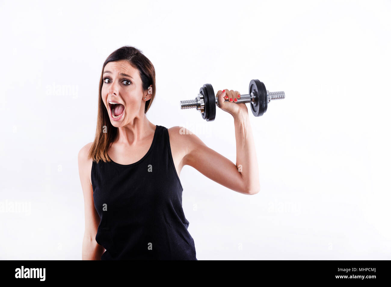 A beautiful young woman lifting weight and screaming Stock Photo - Alamy