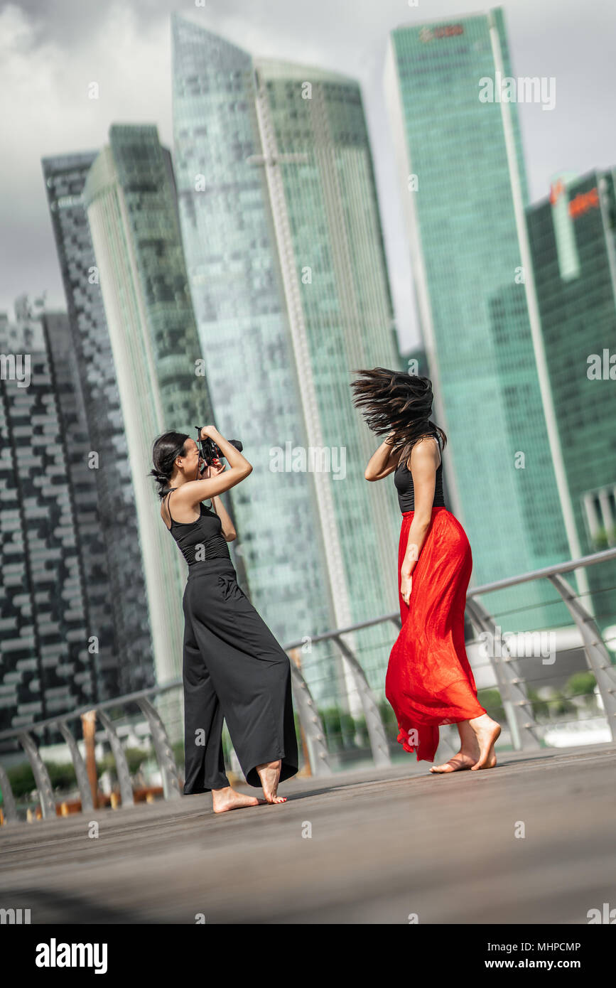 Two beautiful young girls having fun photo shooting on a deck with ...