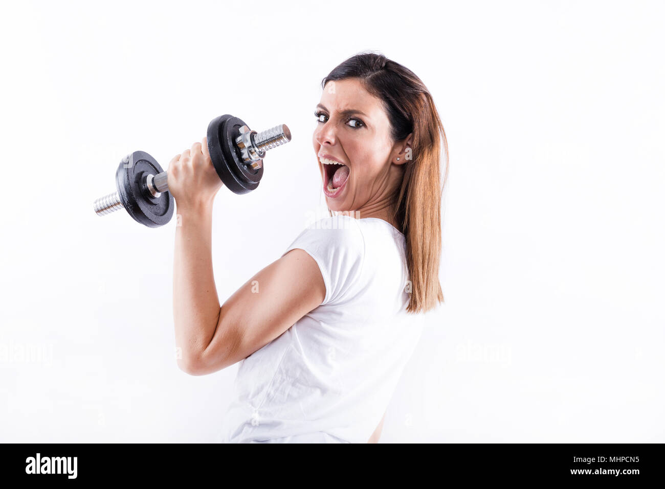A beautiful young woman lifting weight and screaming Stock Photo - Alamy
