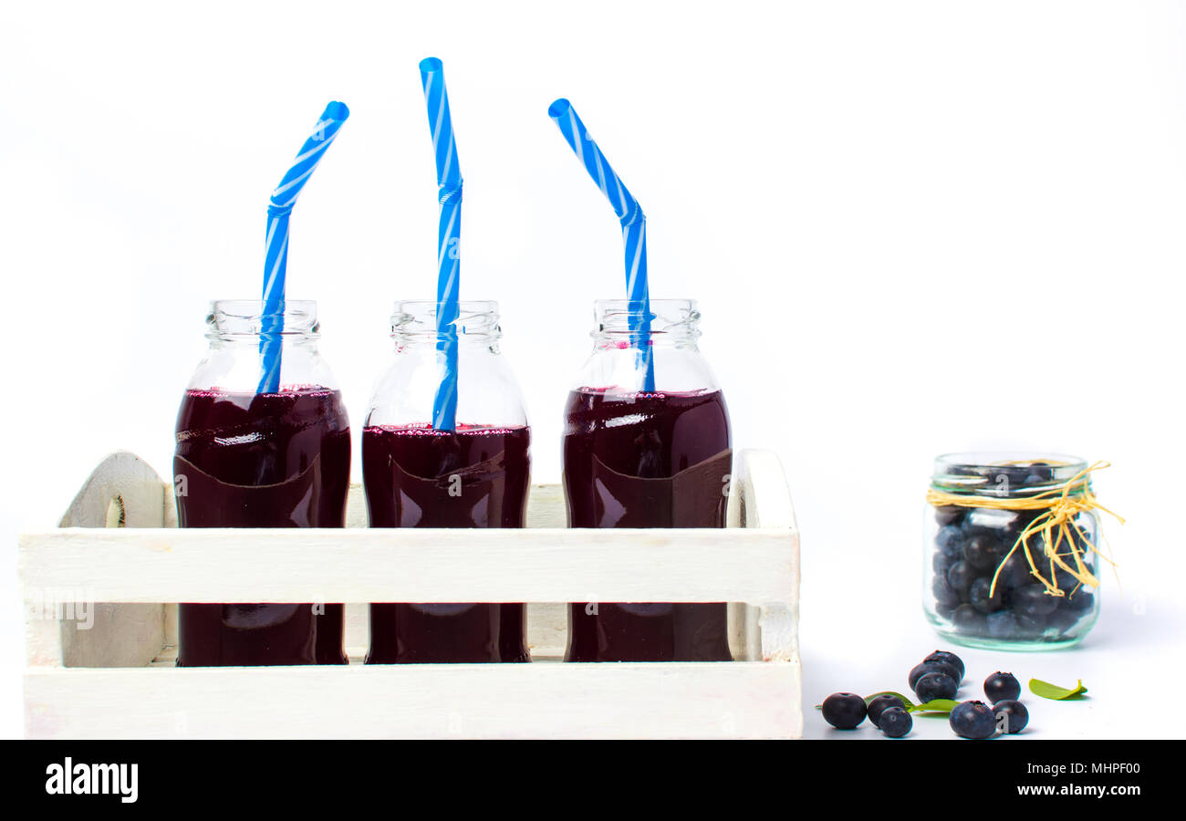 Blueberry juice bottles in a white wooden box isolated Stock Photo - Alamy