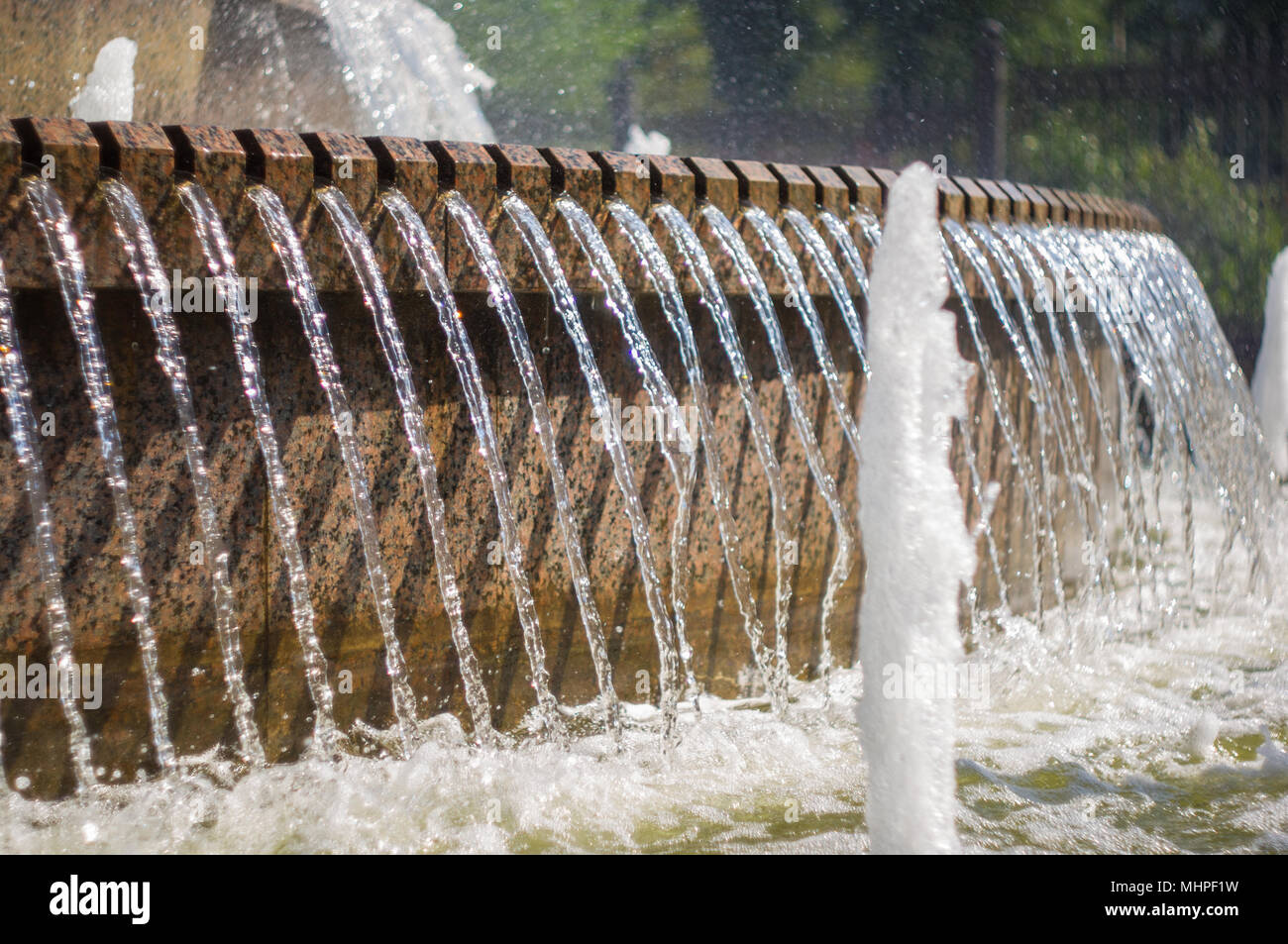Fountain in city park on hot summer day, beautiful bright streams of ...