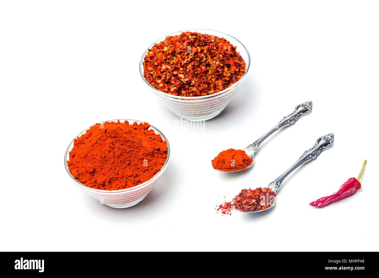 Ground red pepper in a glass bowl isolated Stock Photo - Alamy