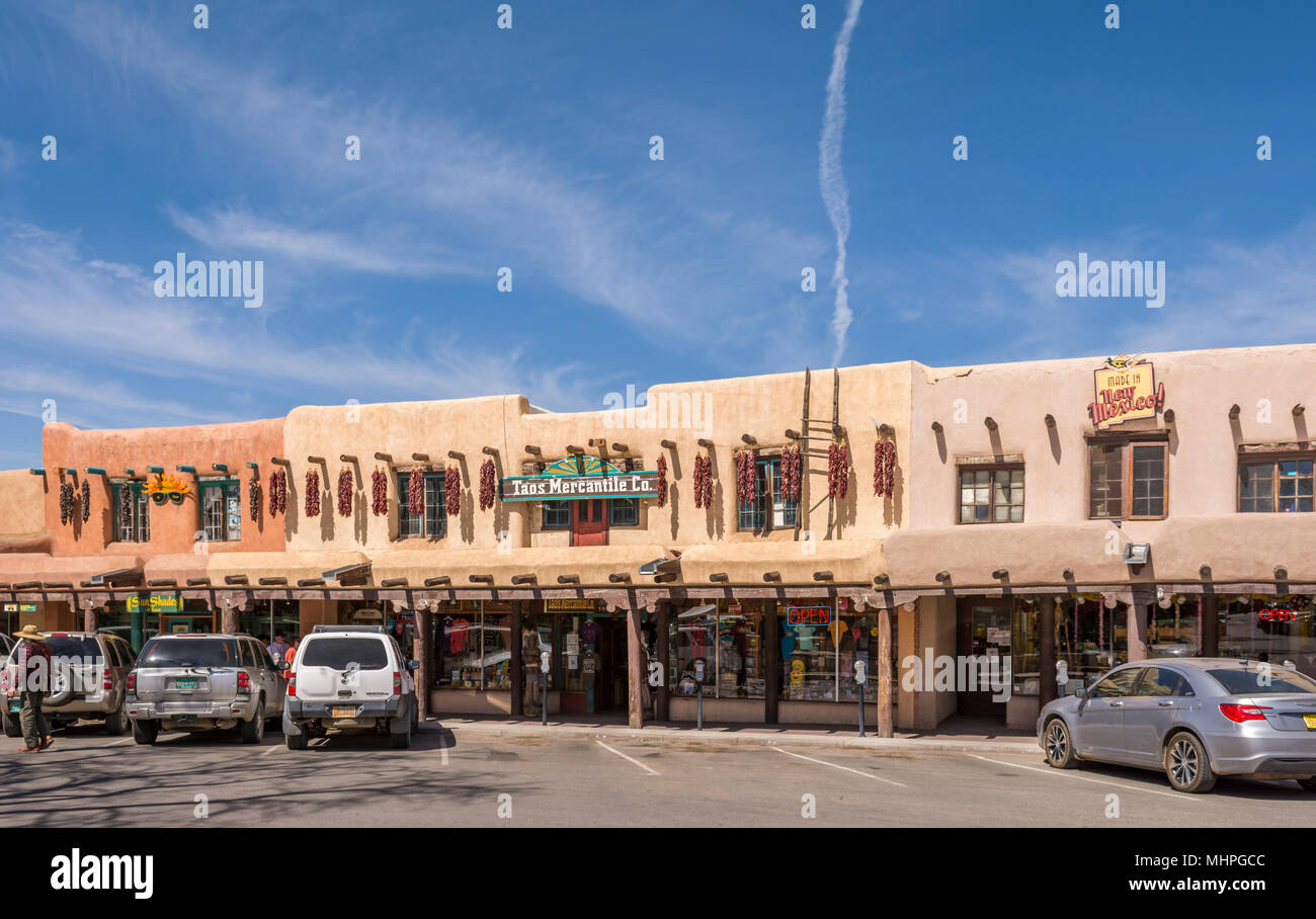 Tourist shops with adobe style architecture on street in Historic Taos ...