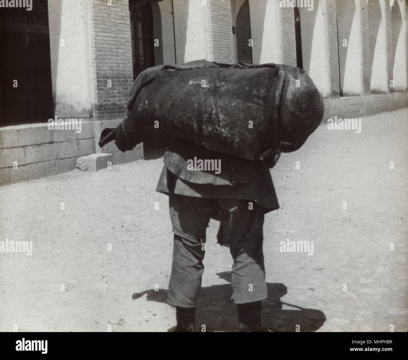 Man carrying a heavy weight Stock Photo - Alamy