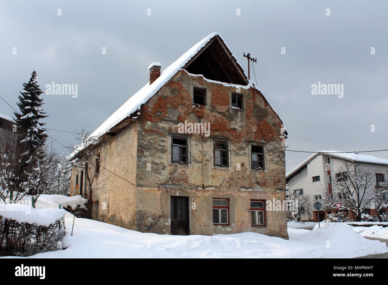 Abandoned old ruined house with broken windows, fallen facade and ...