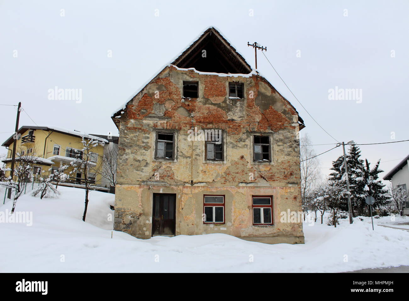 Abandoned old ruined house with broken windows, fallen facade and ...