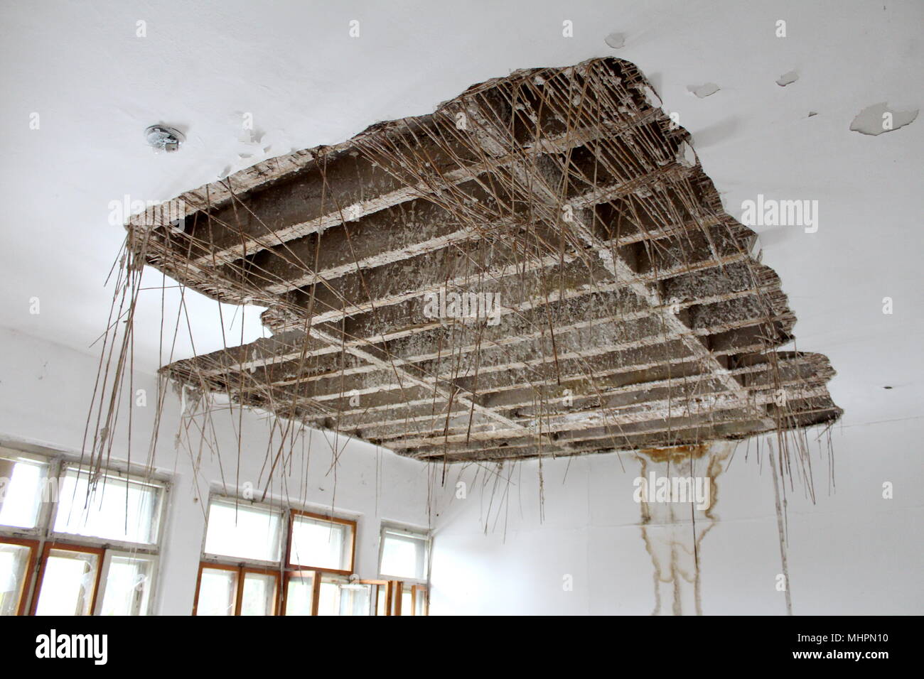 Crumbling ceiling with hanging insulation completely destroyed by ...