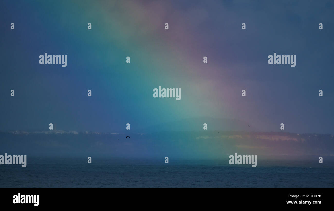 Rainbow over the sea Stock Photo - Alamy