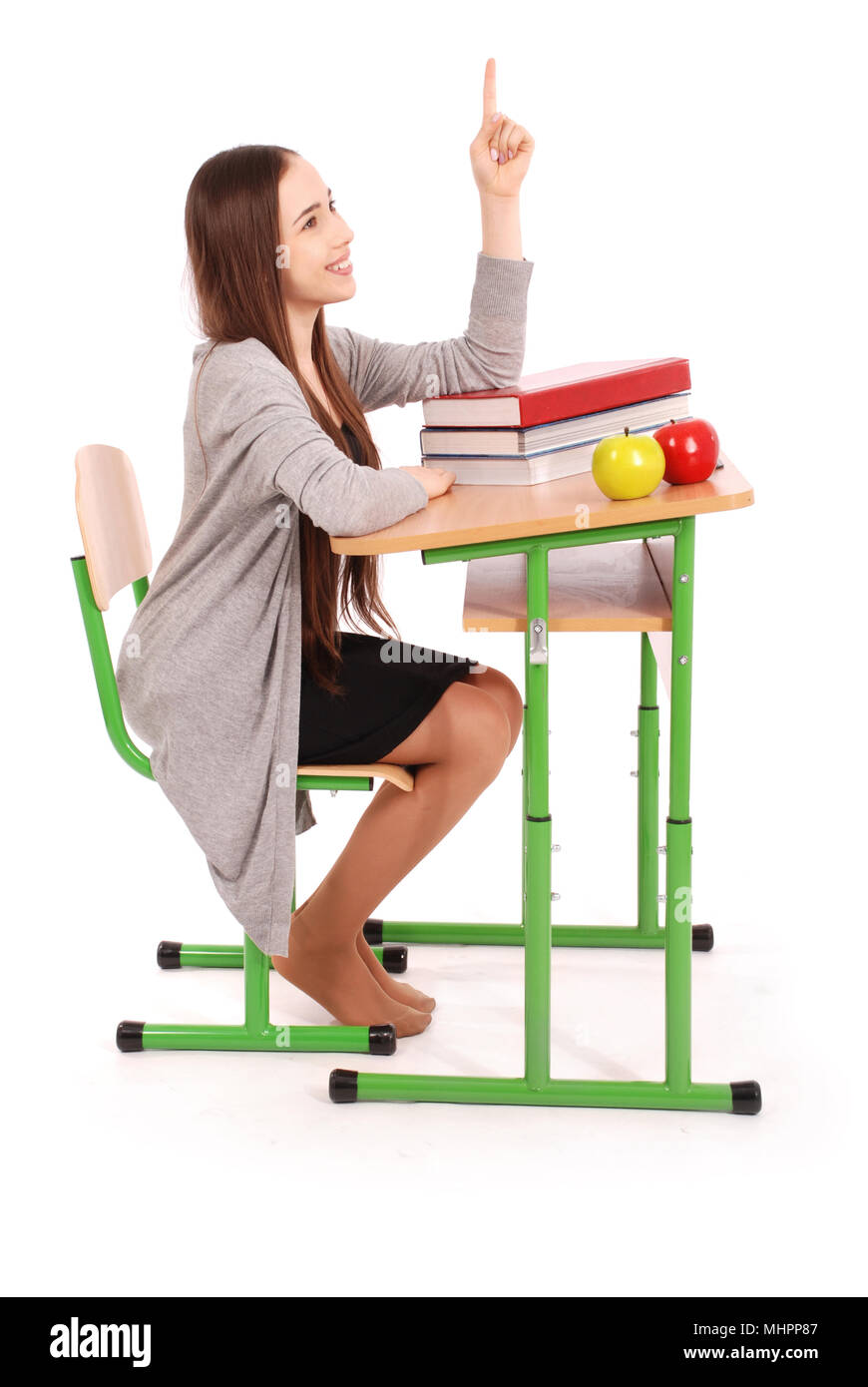 Teenager school girl raising hand to ask question isolated on white ...