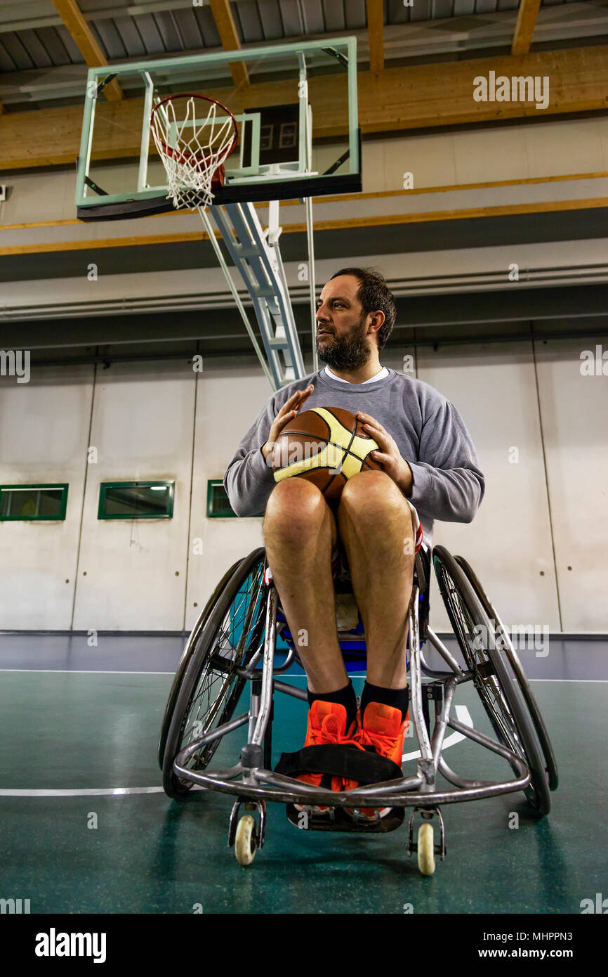 disabled sport men relaxation while playing indoor basketball at a ...