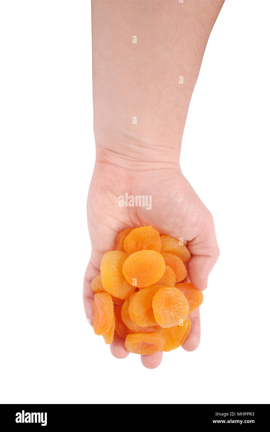 Delicious and healthy dried apricots in hand isolated on white ...