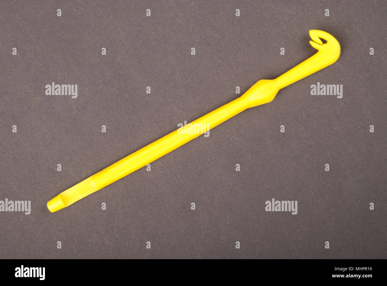 One yellow loop tier isolated on black background Stock Photo - Alamy