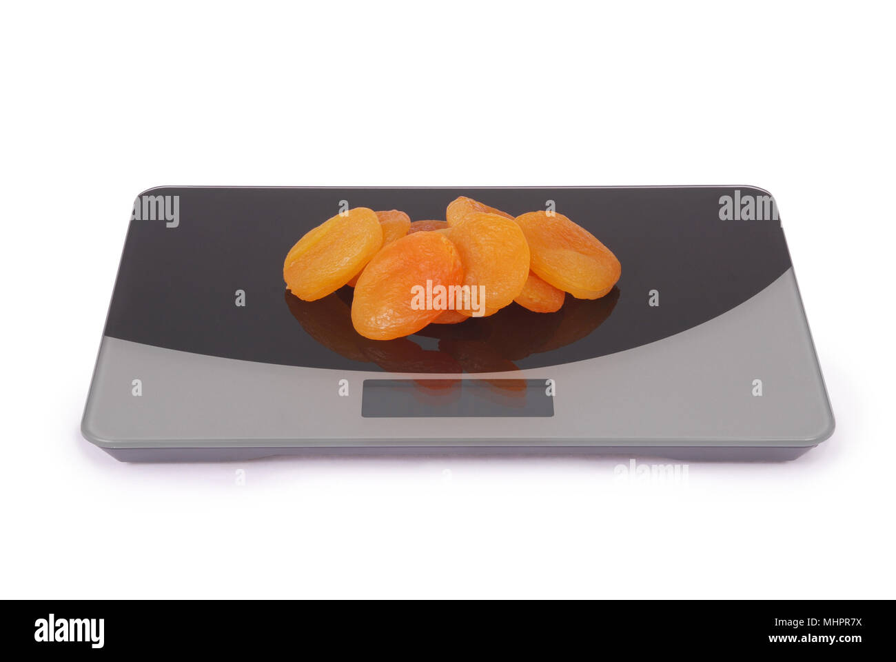 Dried apricot on kitchen scale isolated on white background Stock Photo ...