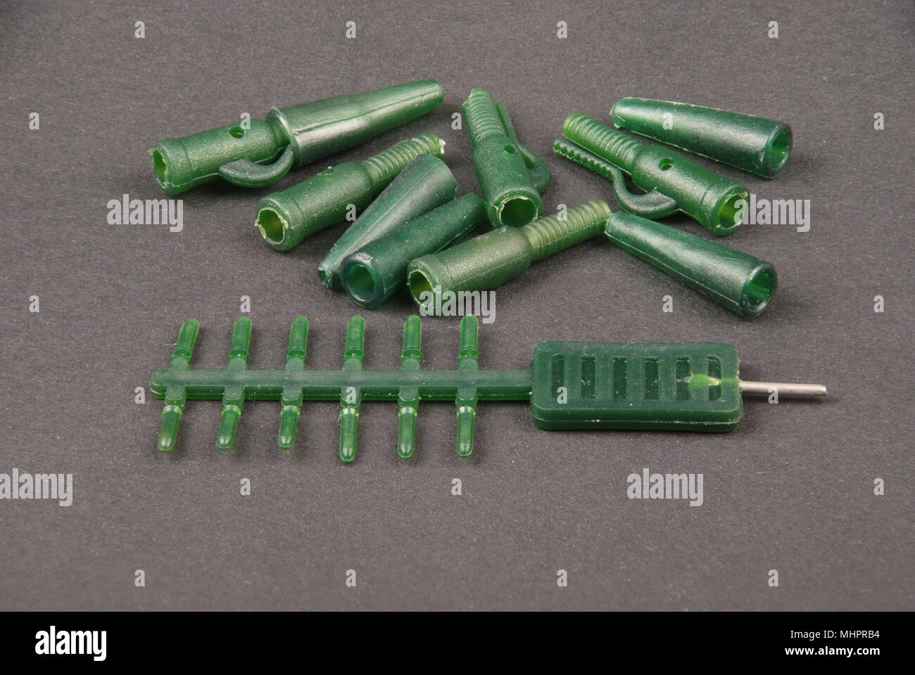 Green safety lead clips isolated on black background Stock Photo - Alamy