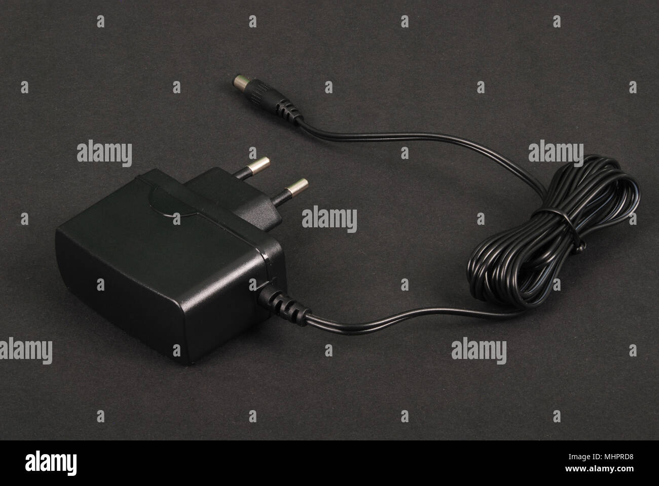 Electric shaver charger isolated on black background Stock Photo - Alamy