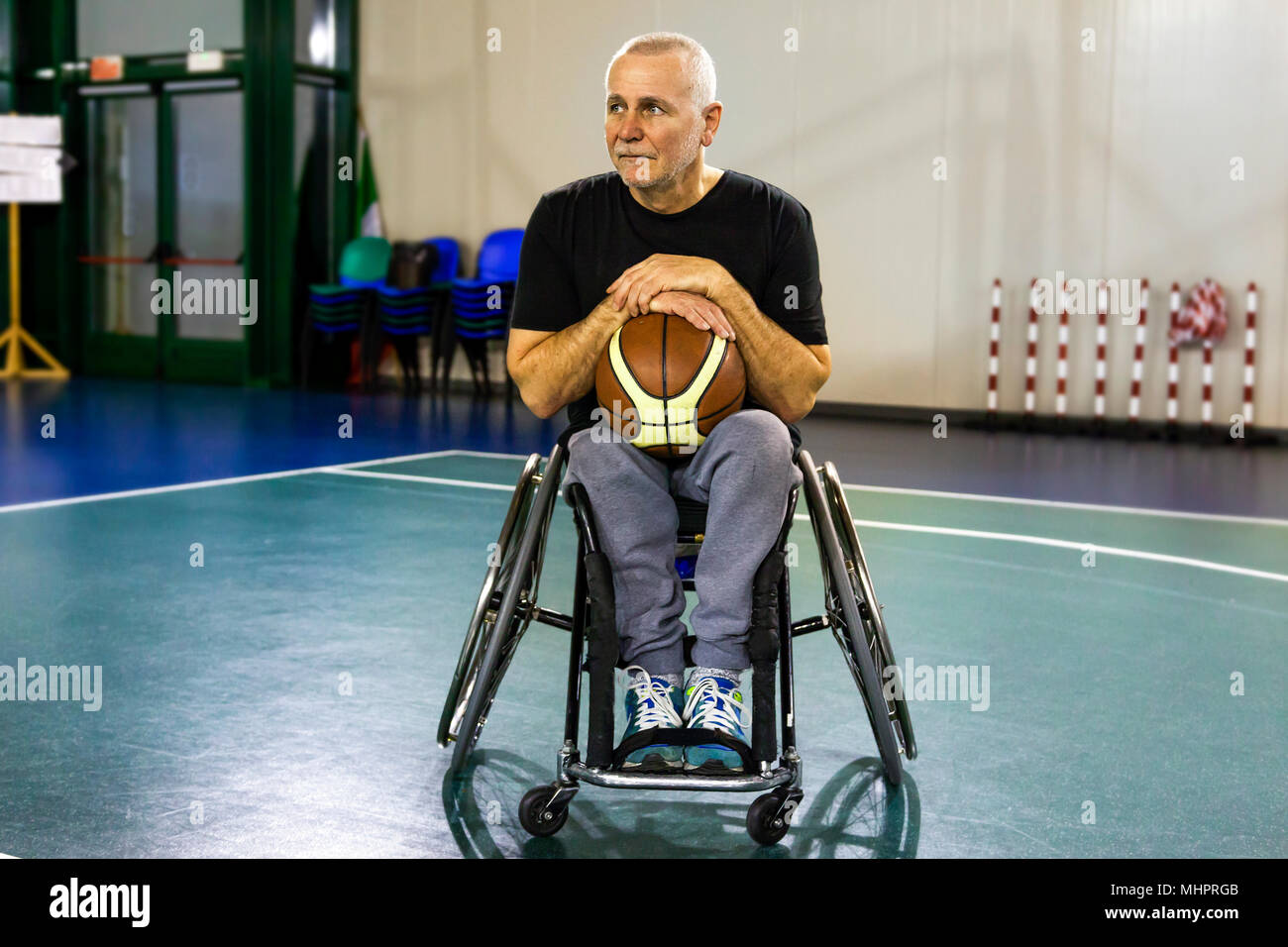disabled sport men relaxation while playing indoor basketball at a ...