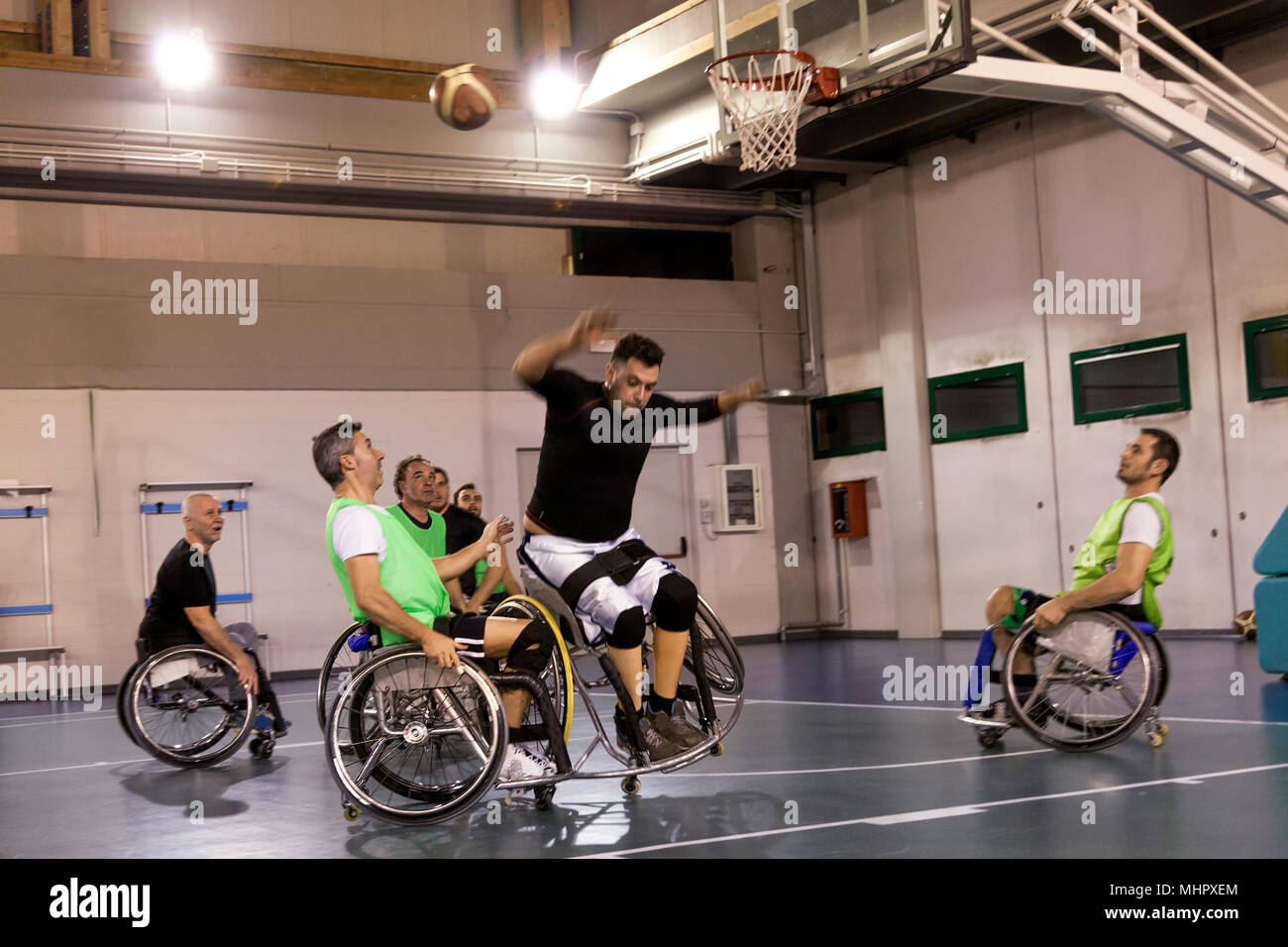 disabled sport men in action while playing indoor basketball at a ...