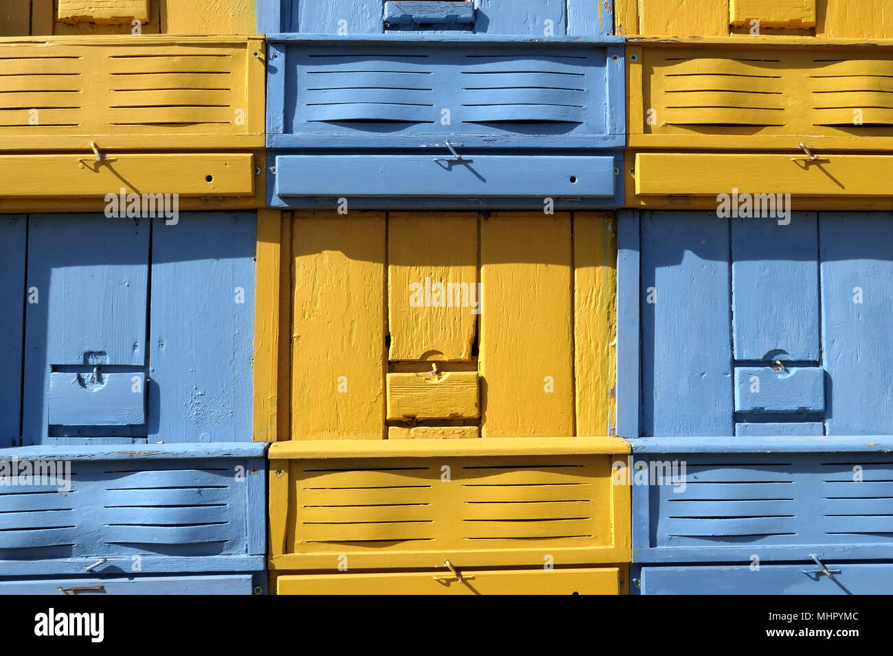 front of a bee hive car with blue and yellow boxes. bee keeper Stock ...