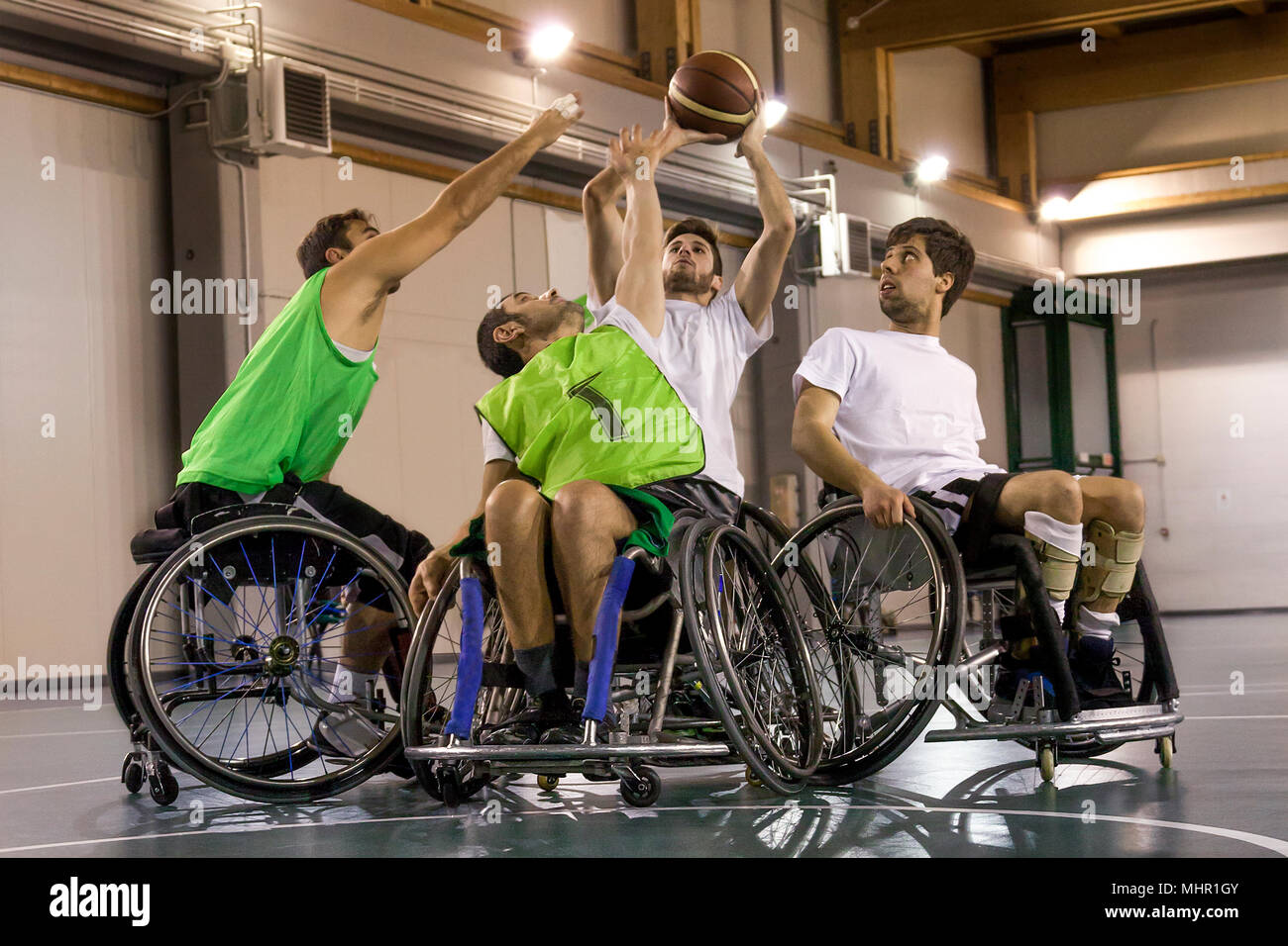 disabled sport men in action while playing indoor basketball at a ...