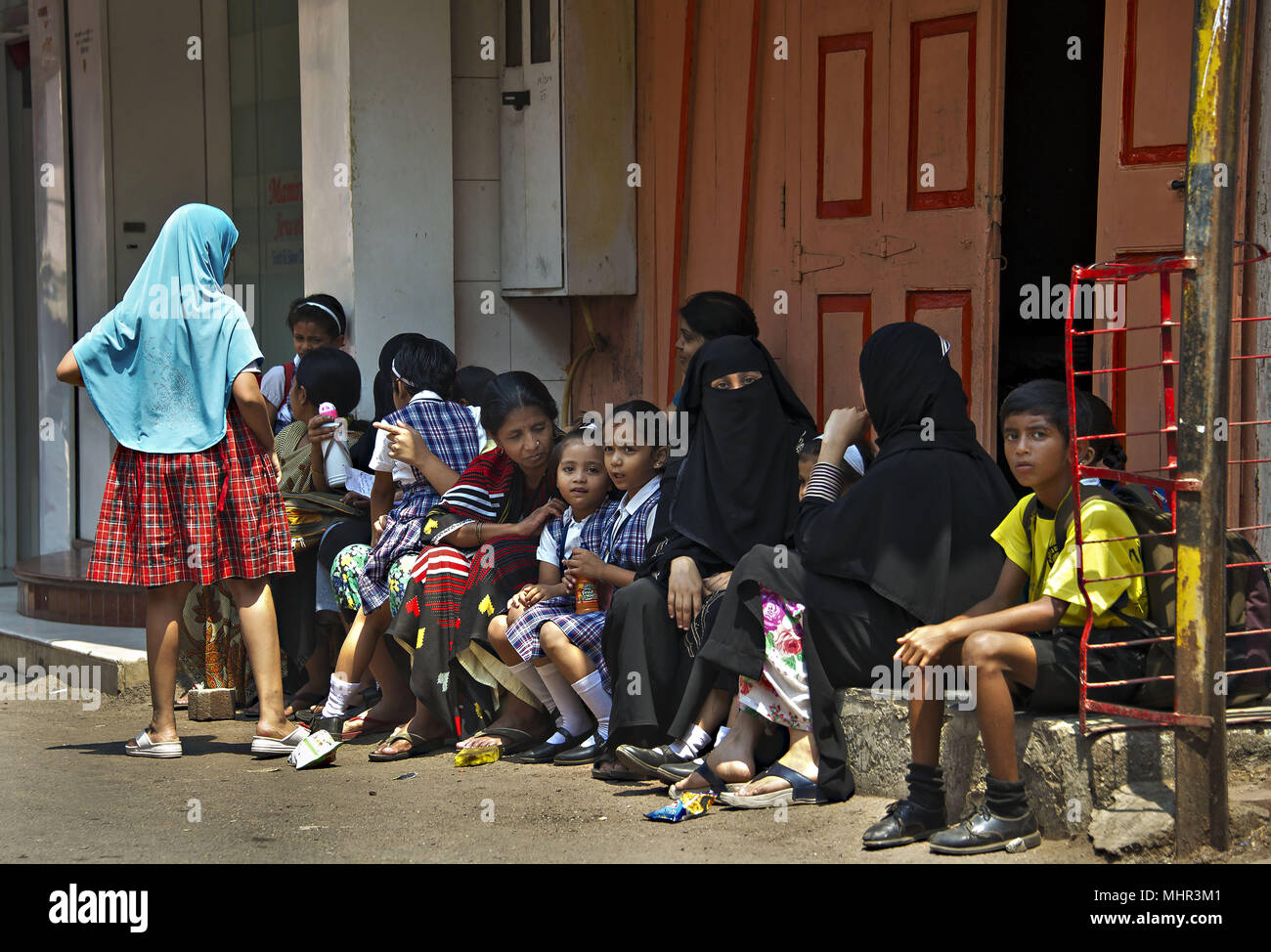 Muslim teachers and students sitting on steps of school in Mumbai ...