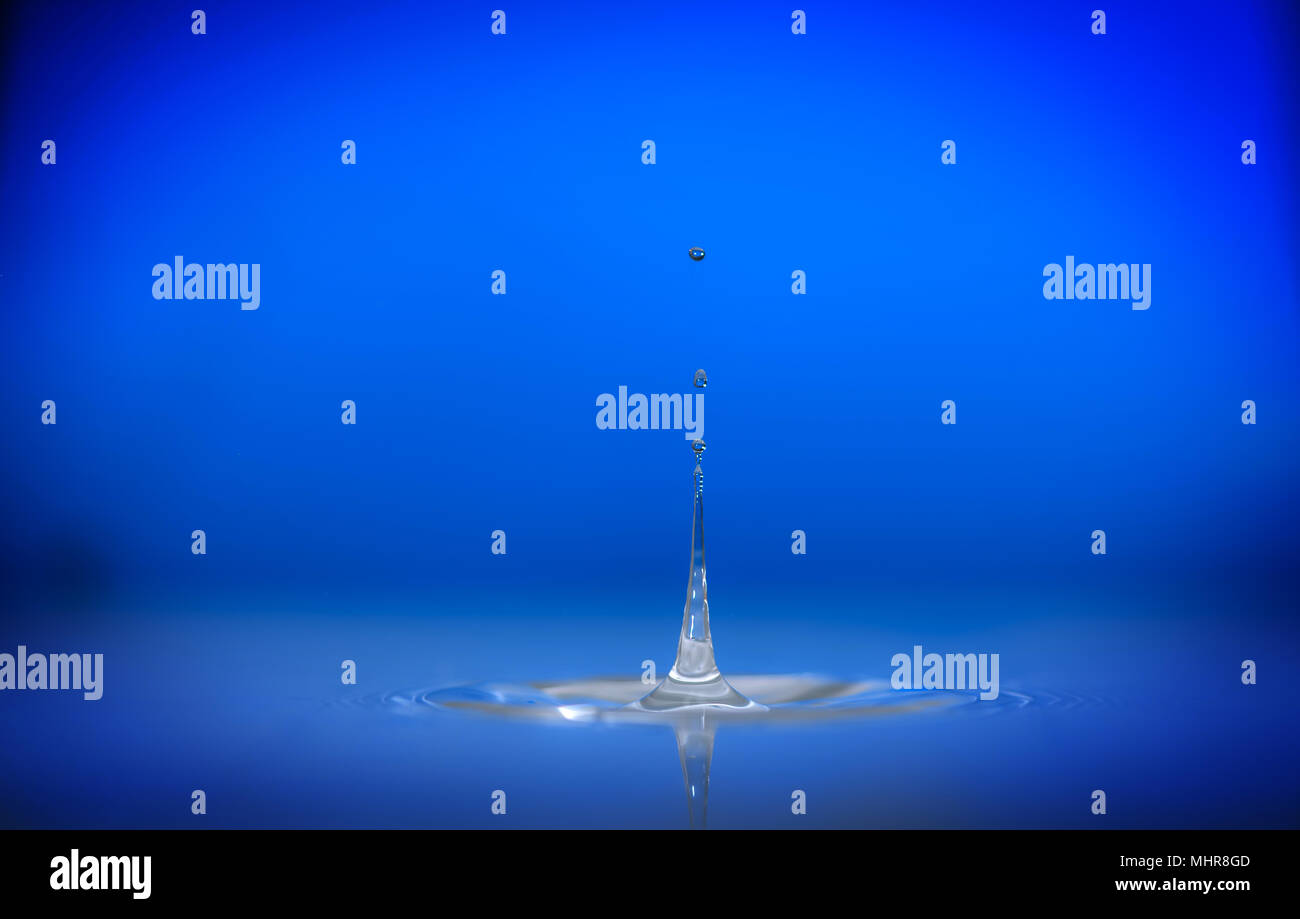 Water drop falling into water making a perfect droplet splash Stock Photo - Alamy