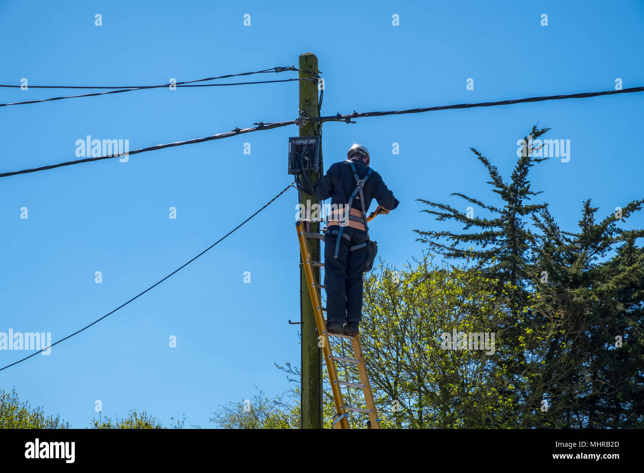 Workman working on a power line. Suffolk, UK Stock Photo - Alamy