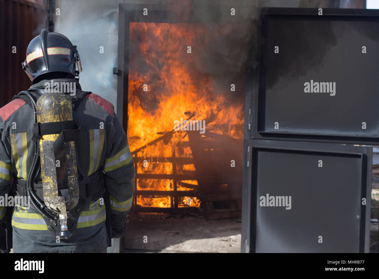 Firefighter putting out fire training station extinguisher backdraft ...