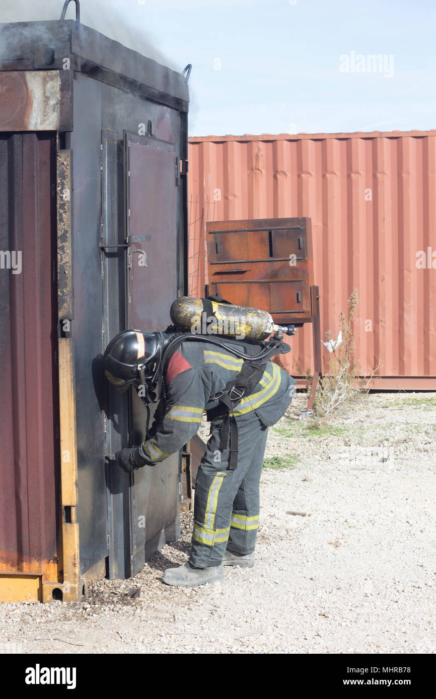 Firefighter putting out fire training station extinguisher backdraft ...