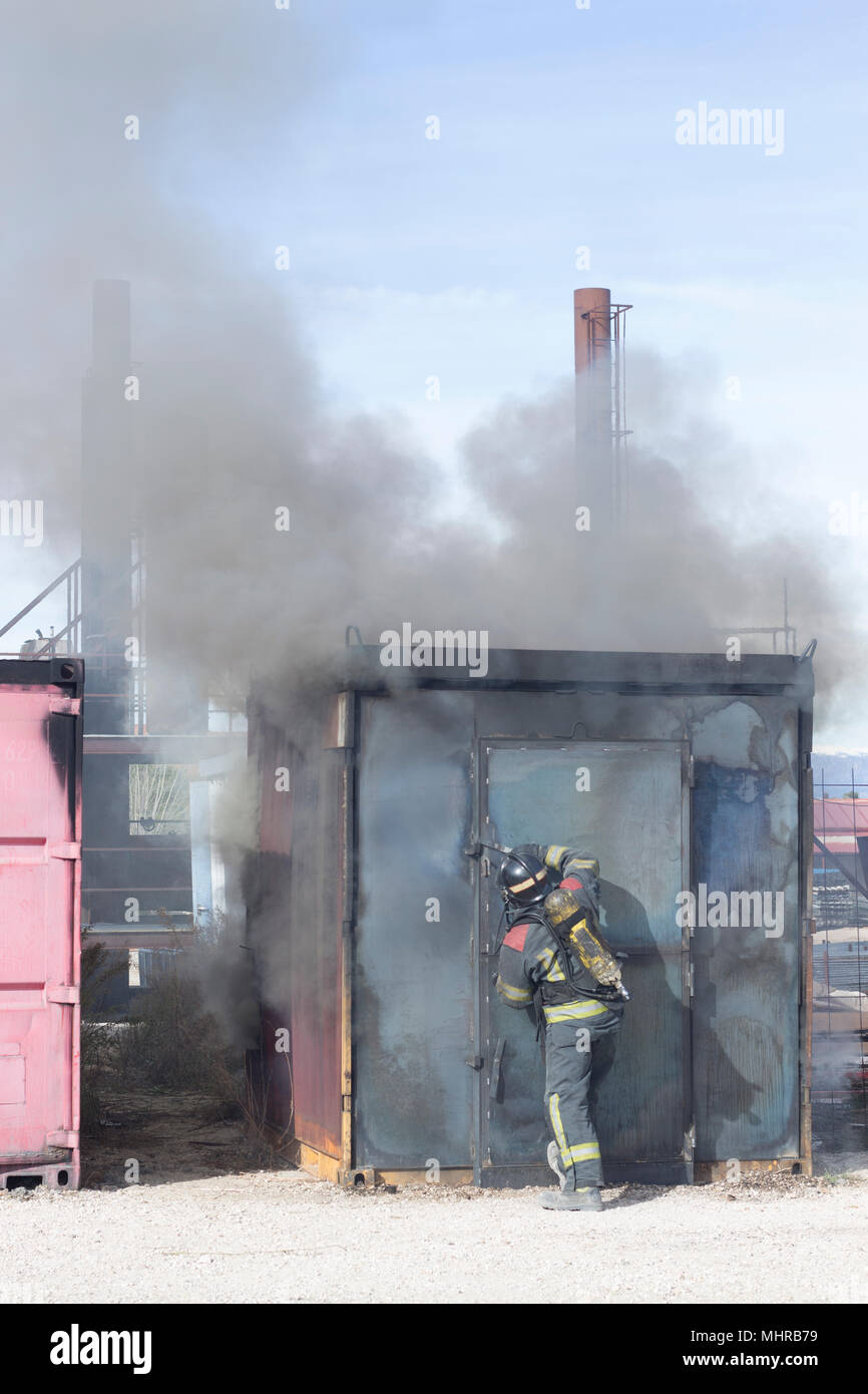 Firefighter putting out fire training station extinguisher backdraft ...