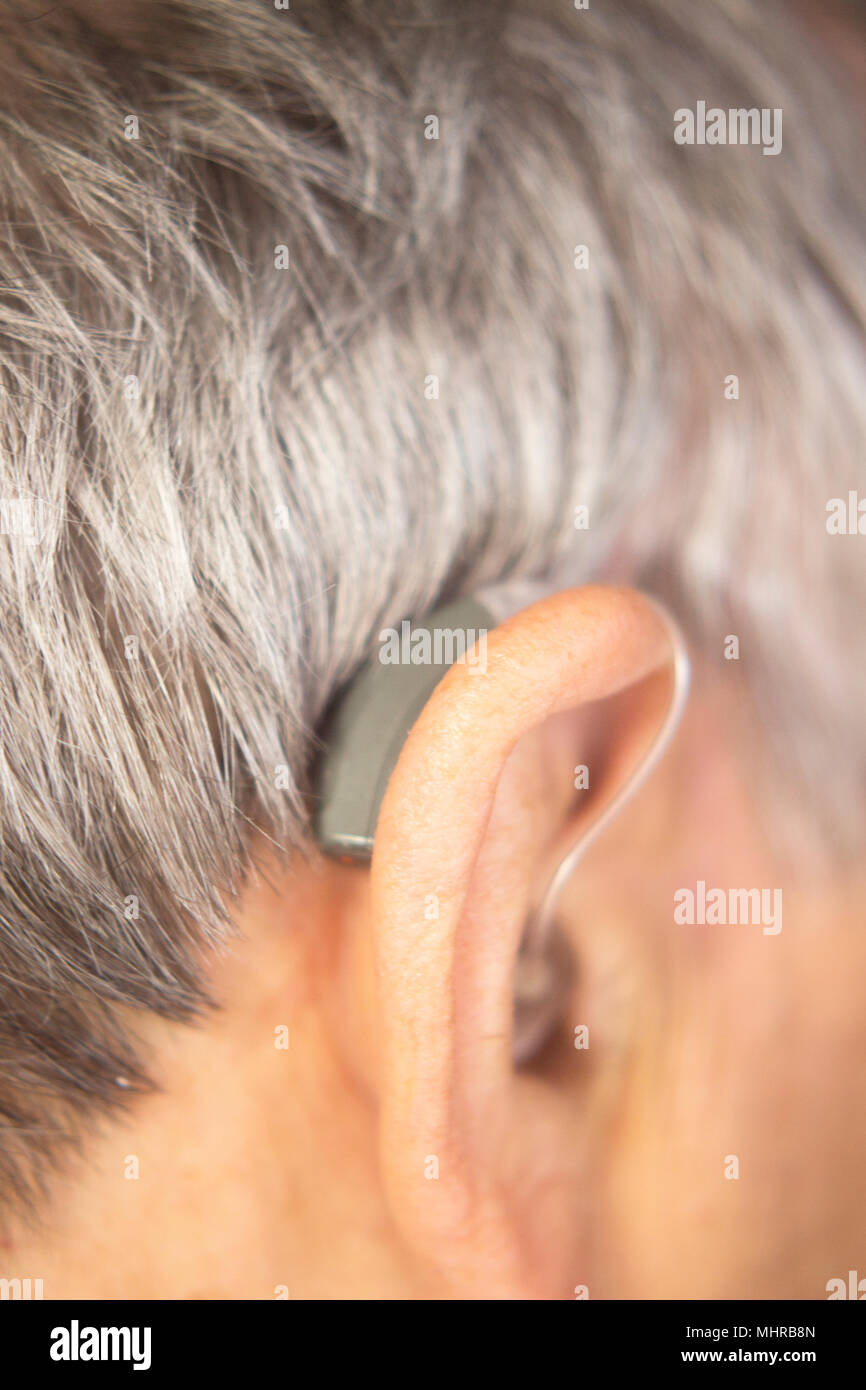 Digital modern hearing aid in the ear of aged old man Stock Photo - Alamy