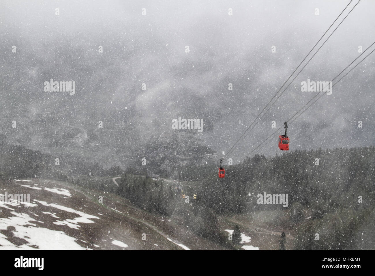 2 red cable carts over the mountain in snow Stock Photo - Alamy