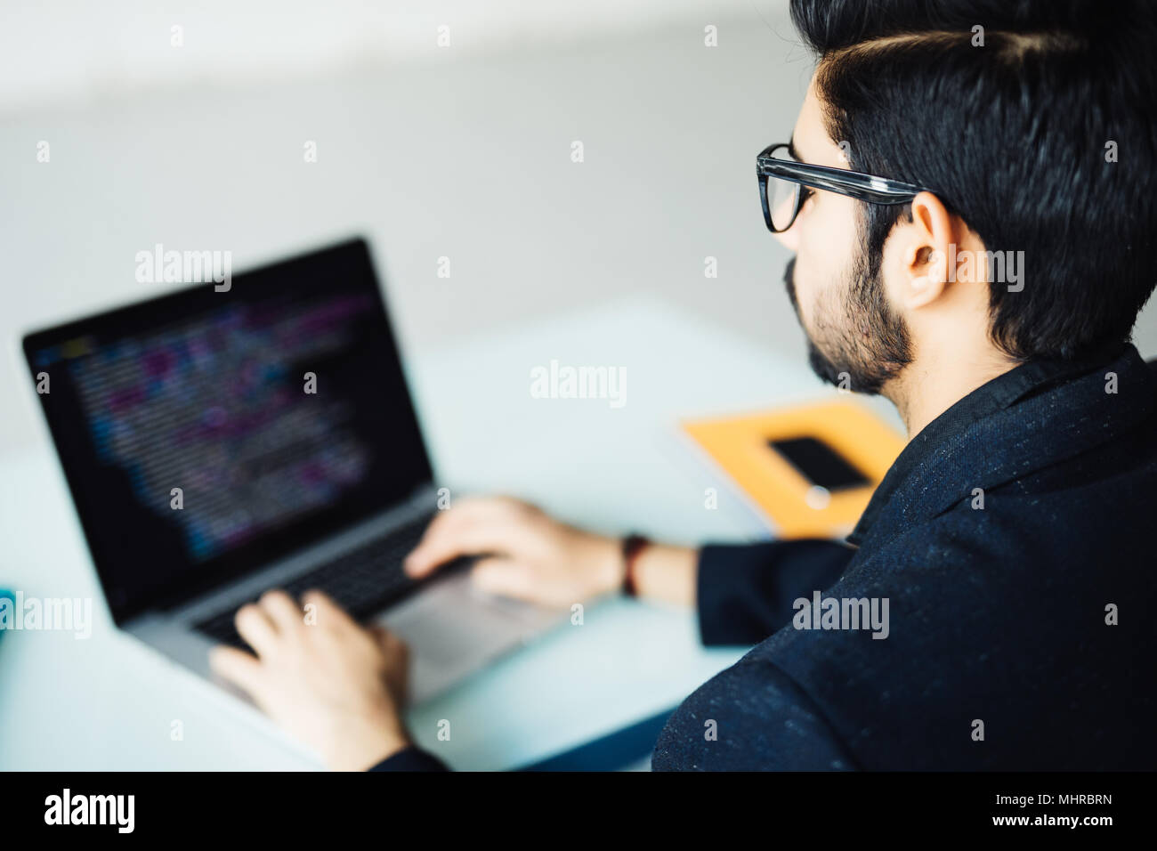 Indian software developer busy with work on new project Stock Photo - Alamy