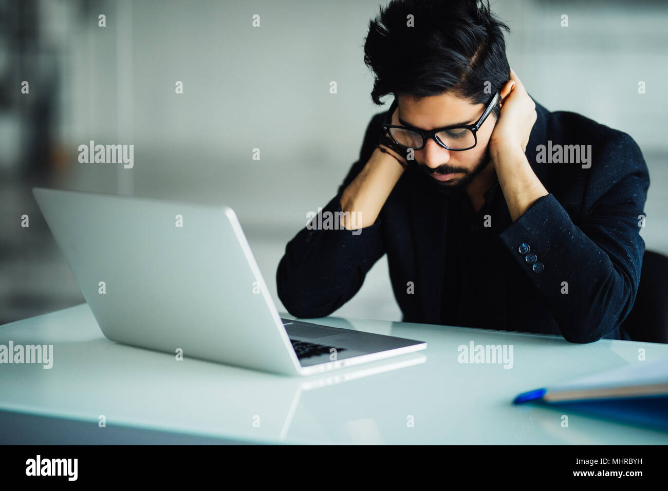 Tired and worried indian business man at workplace in office Stock ...