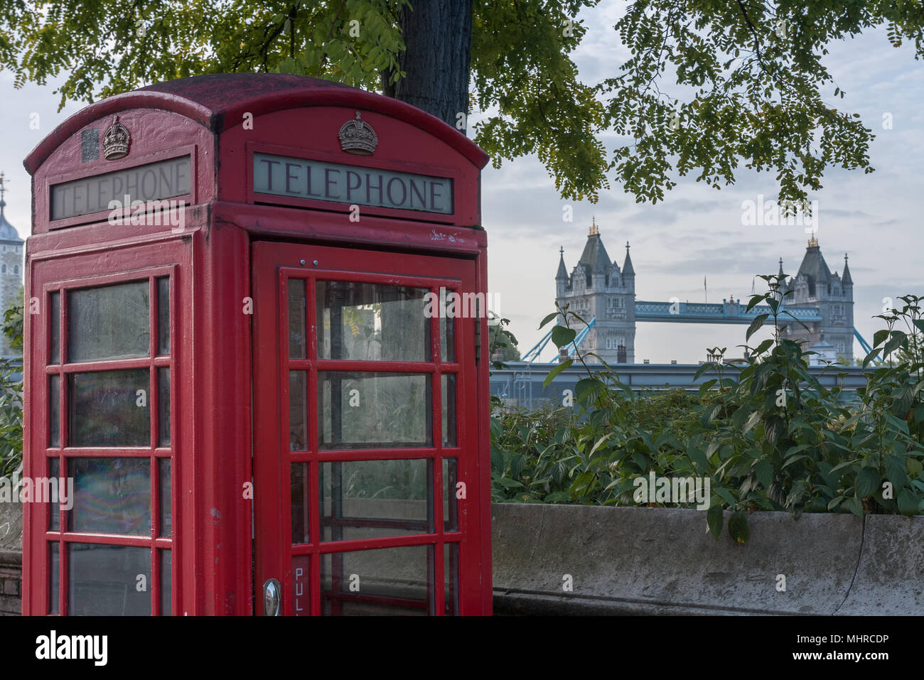 The red telephone box, on background Tower Bridge, two famous icons of ...
