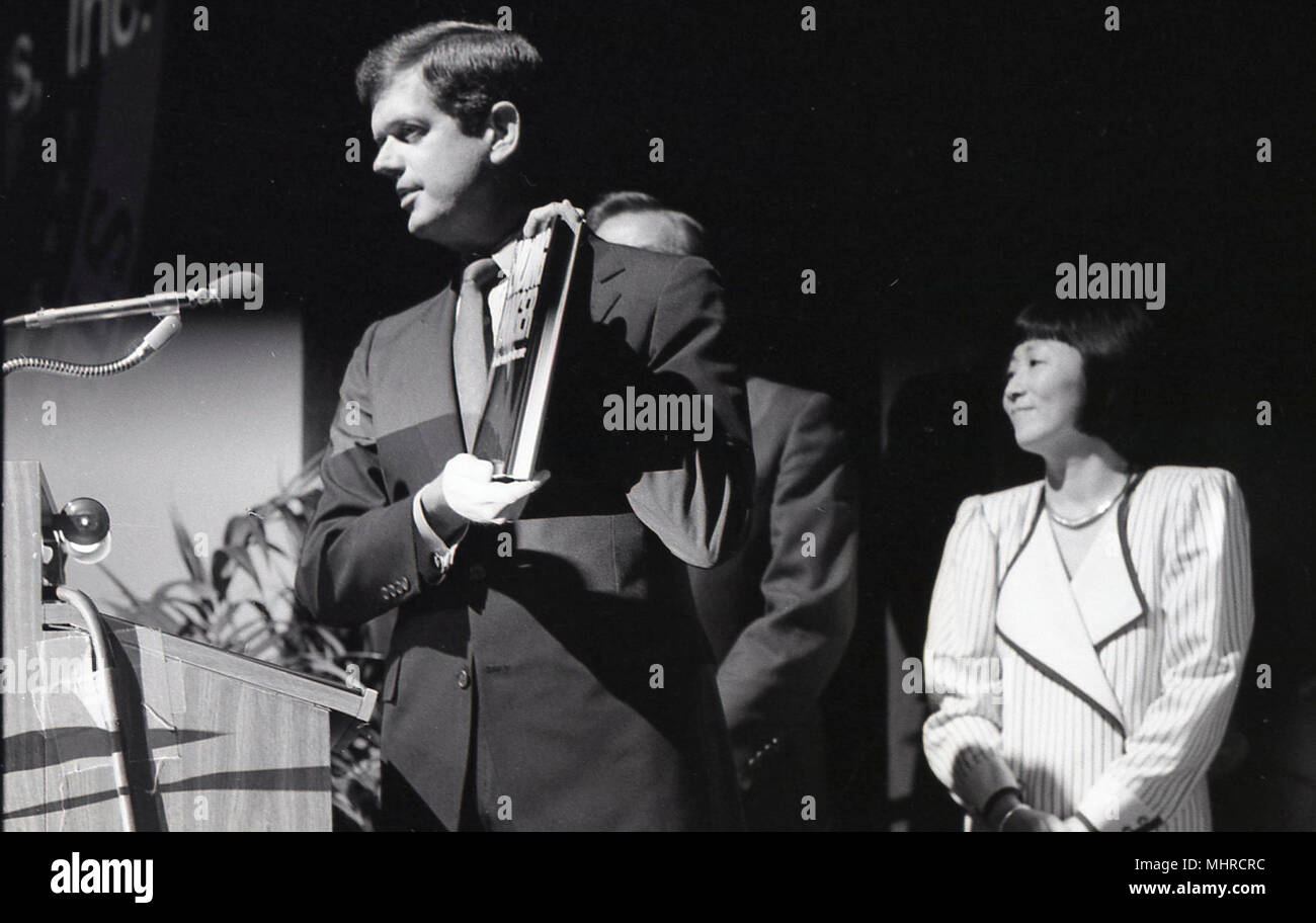Snapshot of a man holding up a book Stock Photo - Alamy