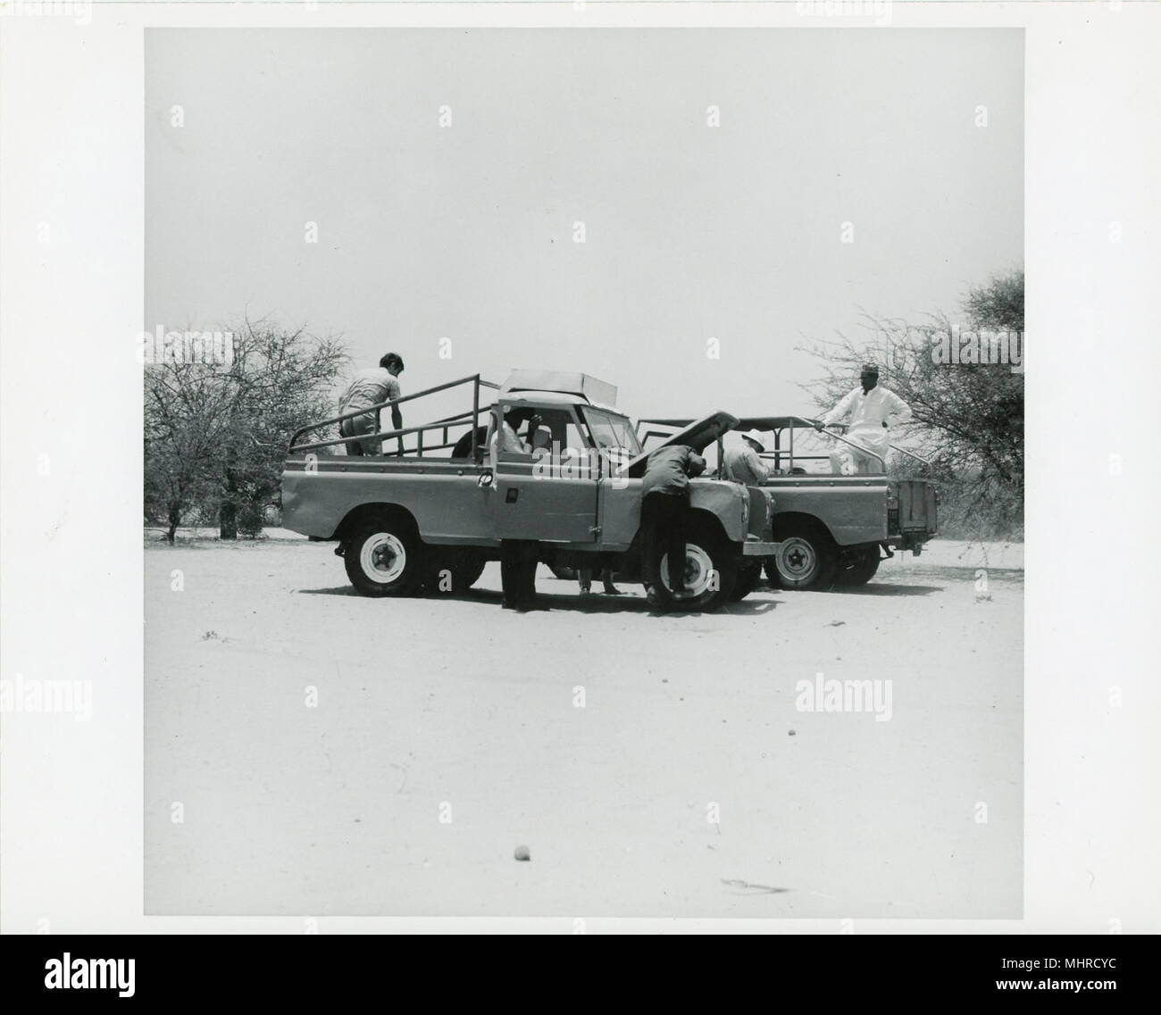 Snapshot of a man working under the hood of a truck Stock Photo - Alamy