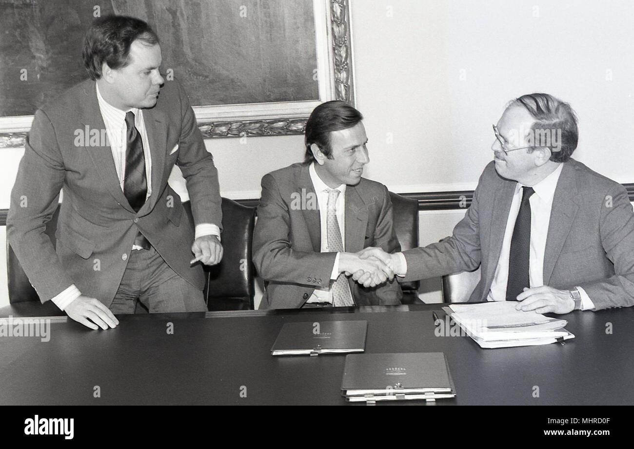 Black and white photo of three men sitting at a table Stock Photo - Alamy