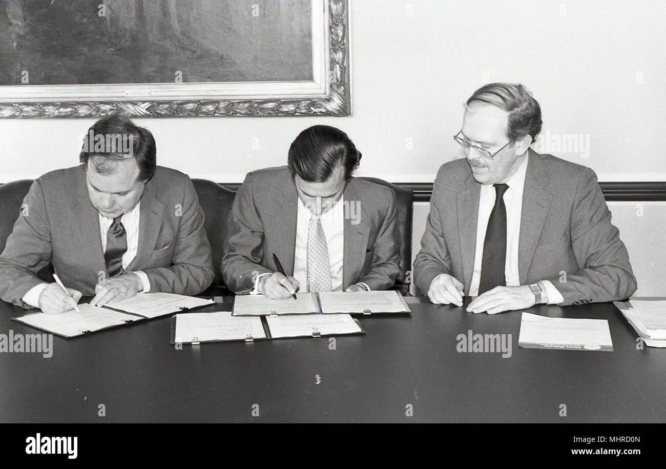 Black and white photo of three men sitting at a table Stock Photo - Alamy