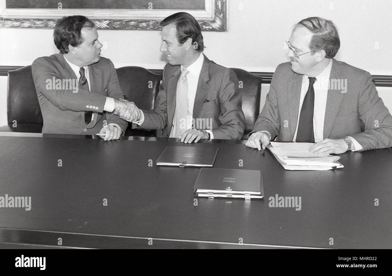 Black and white photo of three men sitting at a table Stock Photo - Alamy