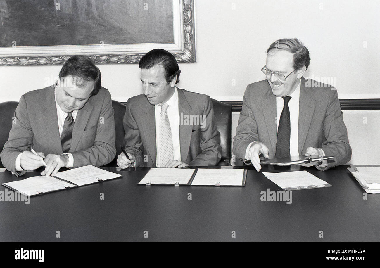 Black and white photo of three men sitting at a table Stock Photo - Alamy