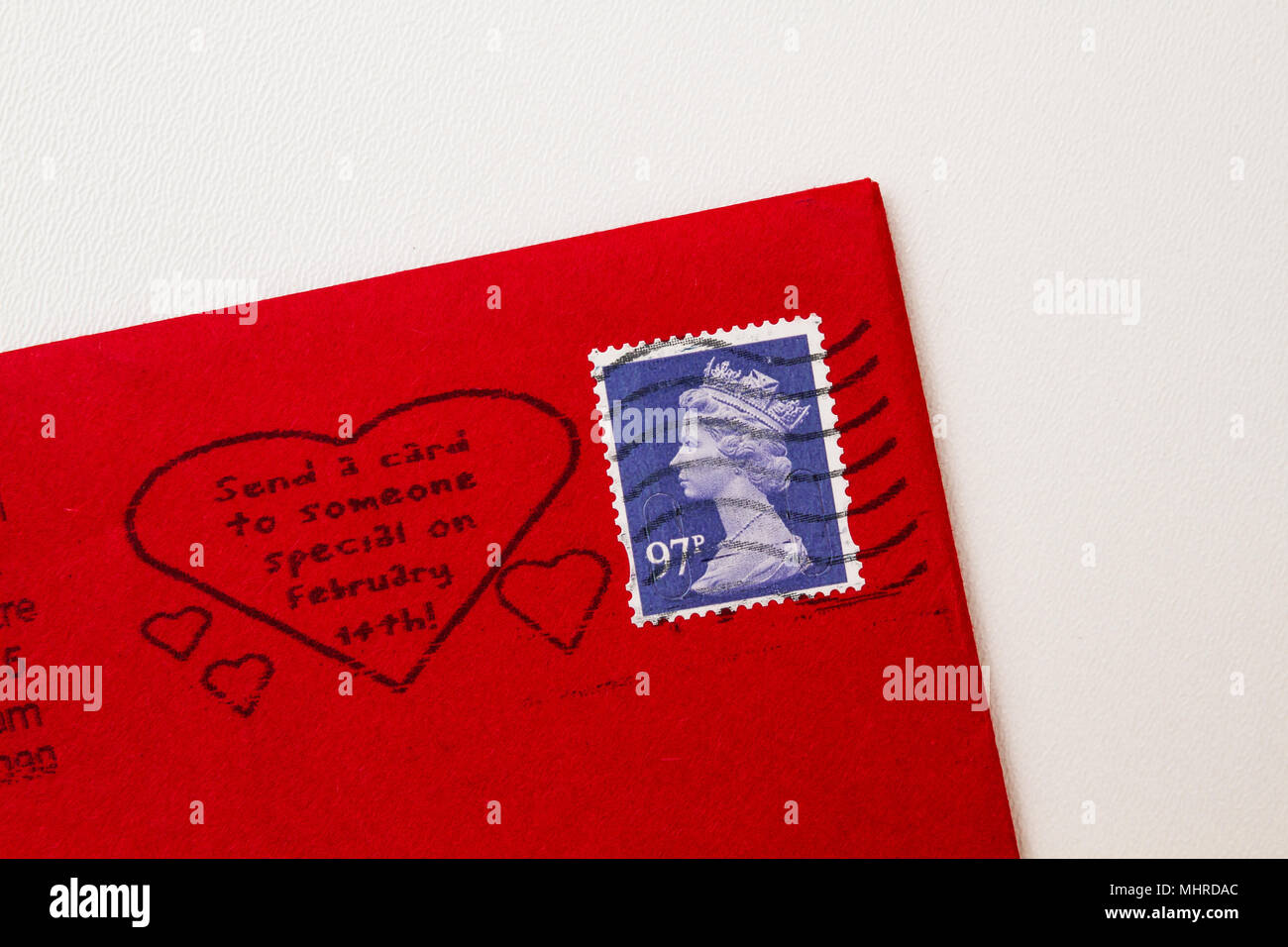 Red envelope corner with a blue stamp of Queen Elisabeth II. UK postage ...