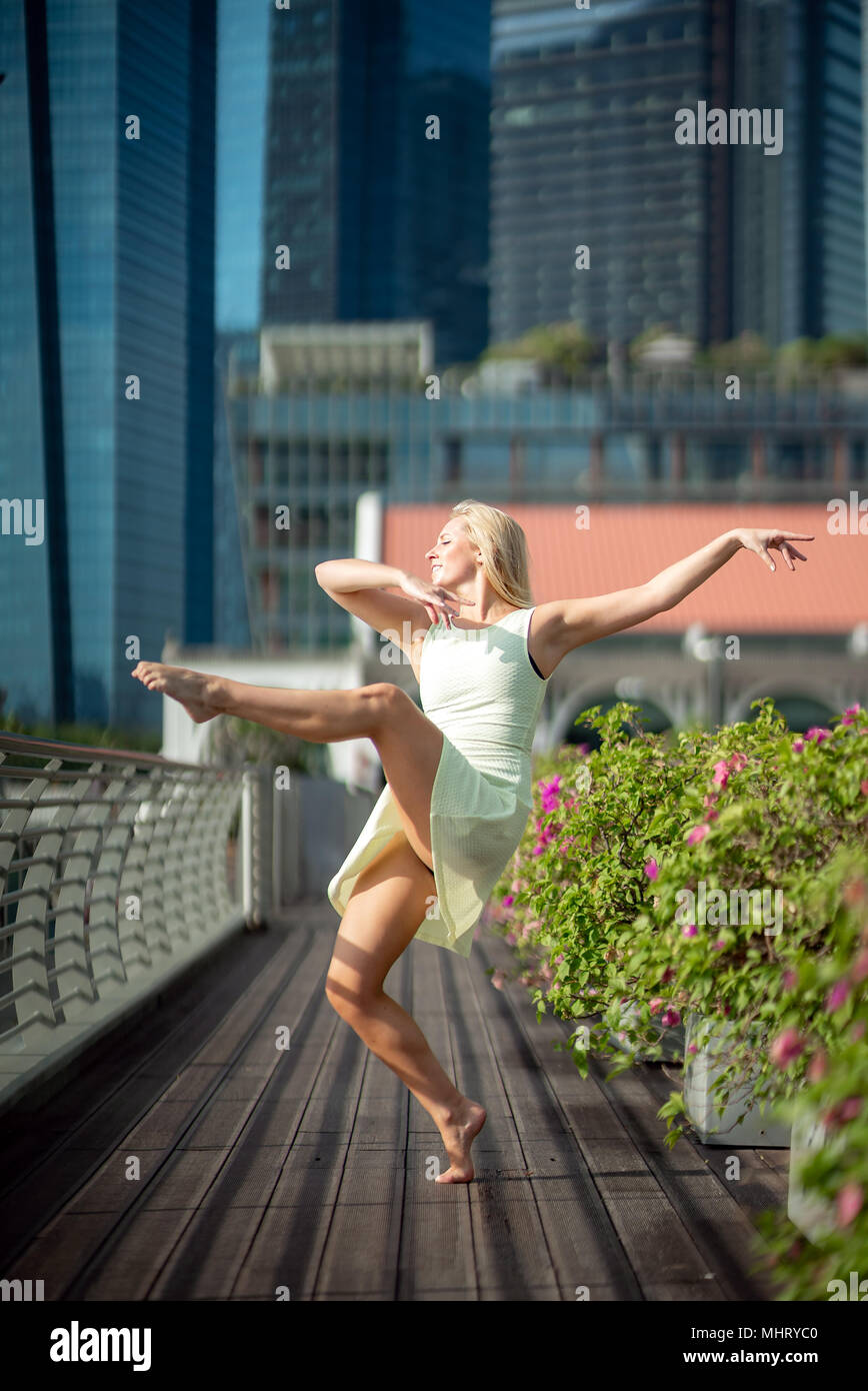 Beautiful Young Girl Dancing on a bridge Stock Photo - Alamy