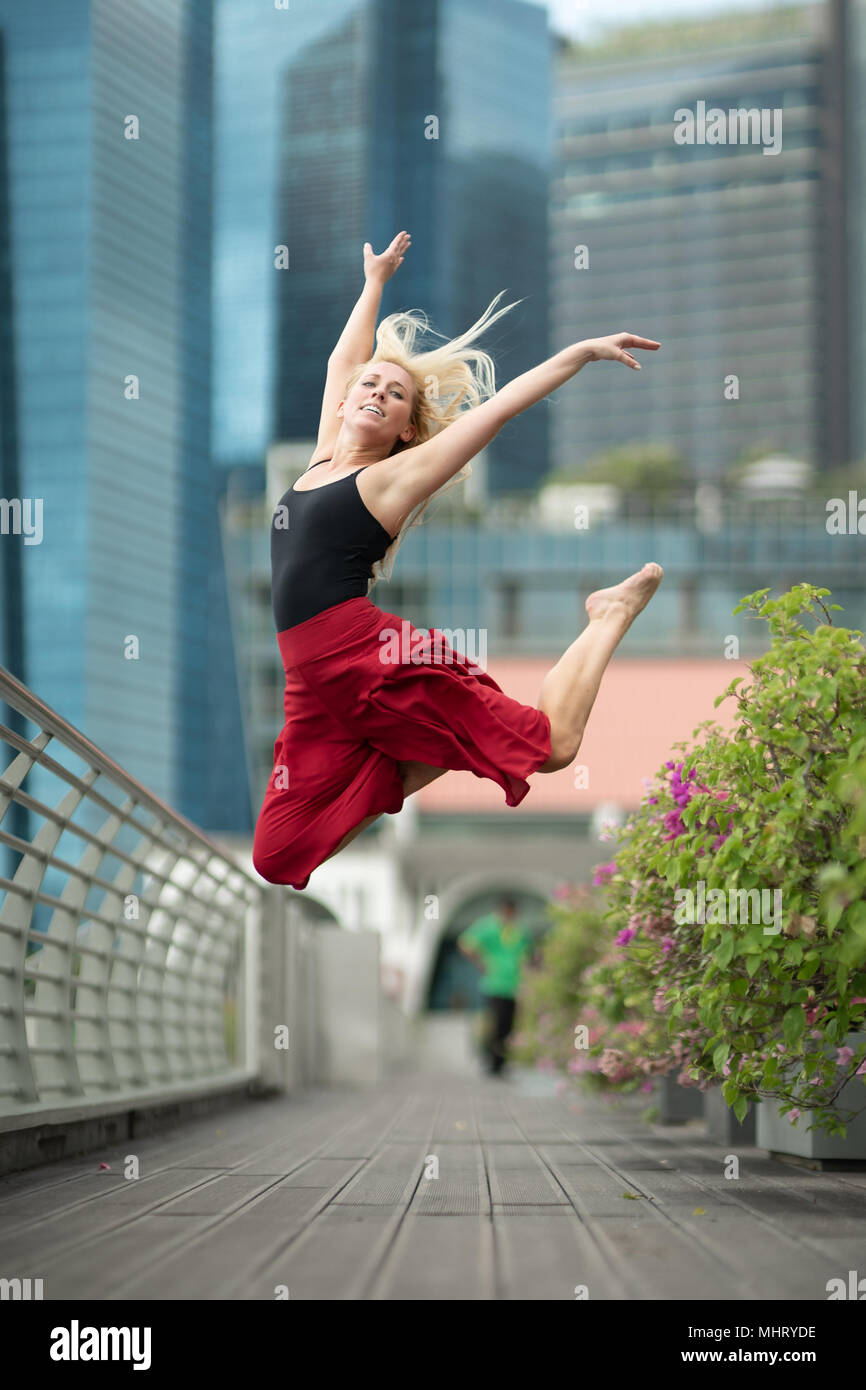 Beautiful Young Girl Dancing on a bridge Stock Photo - Alamy