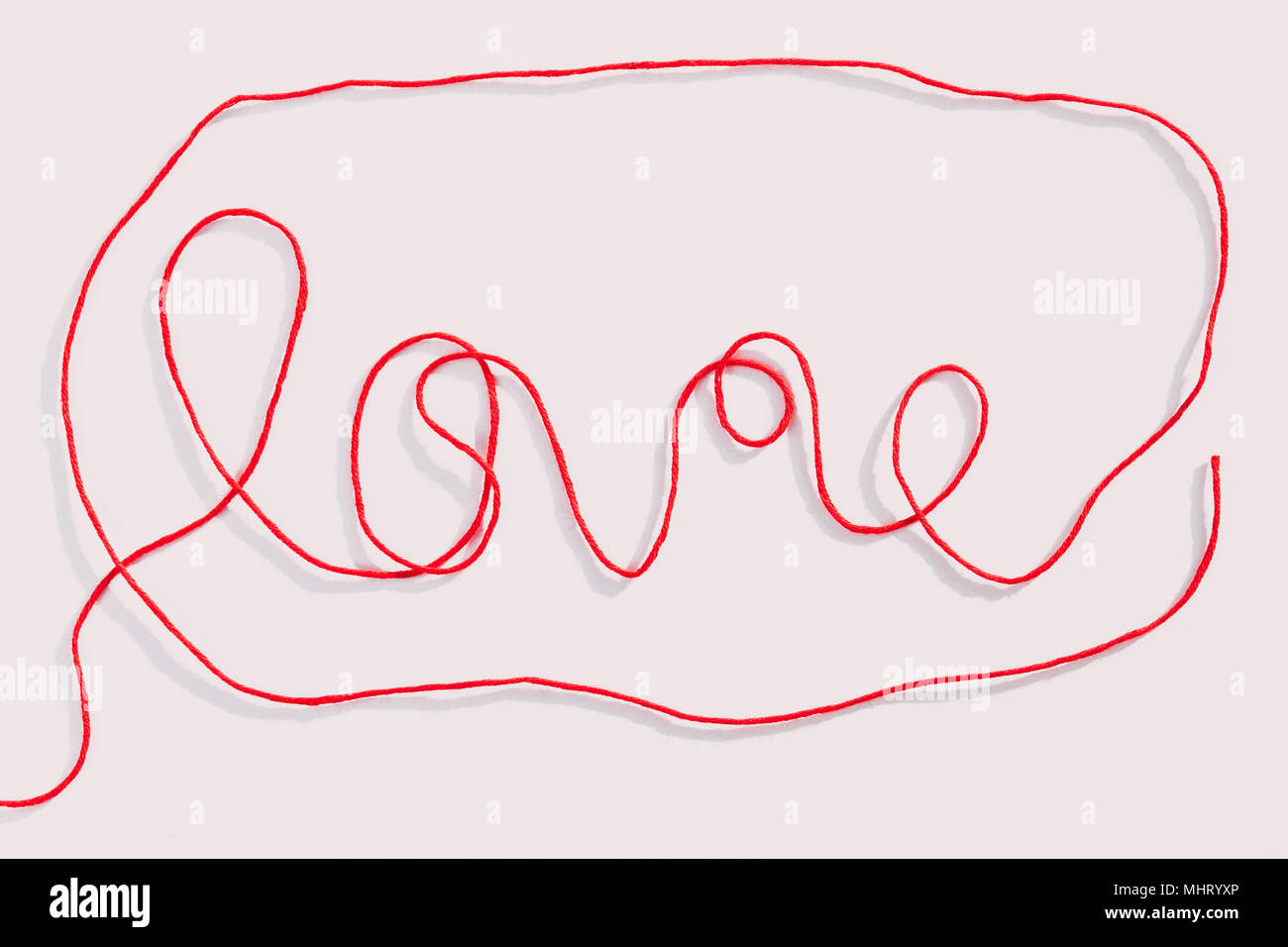 Word love written with red wool thread isolated on white background ...