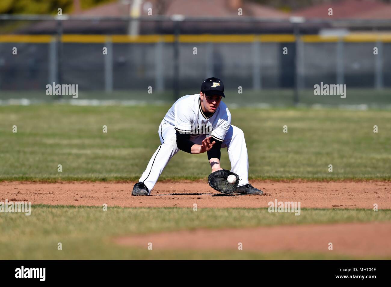 Shortstop fielding a ground ball prior to throwing on to first base to ...