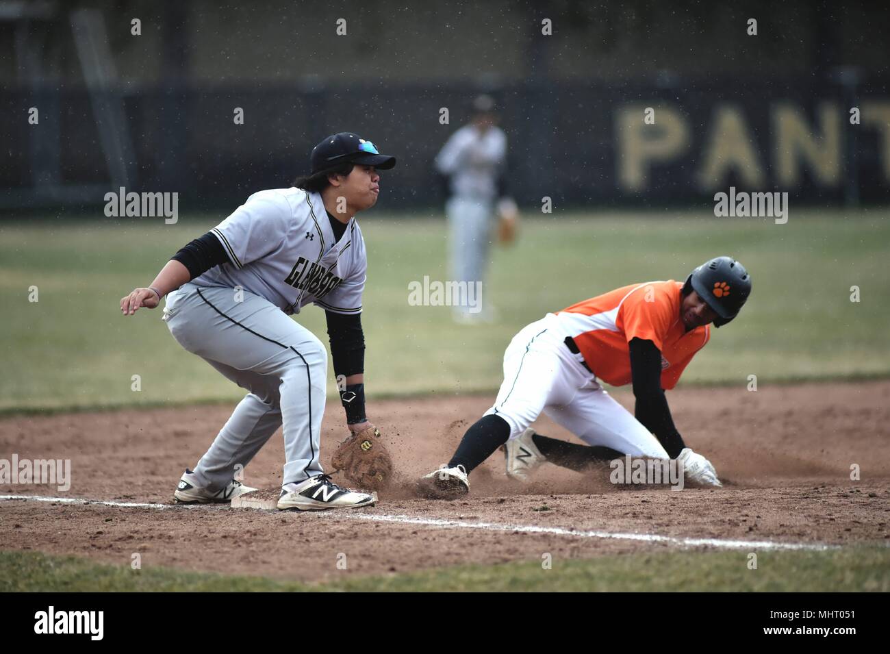 Third baseman attempting to retire a sliding opponent who was ruled ...