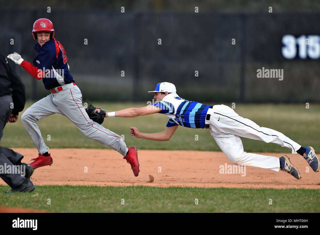 First baseman making a diving tag on a baserunner that had been caugnt ...