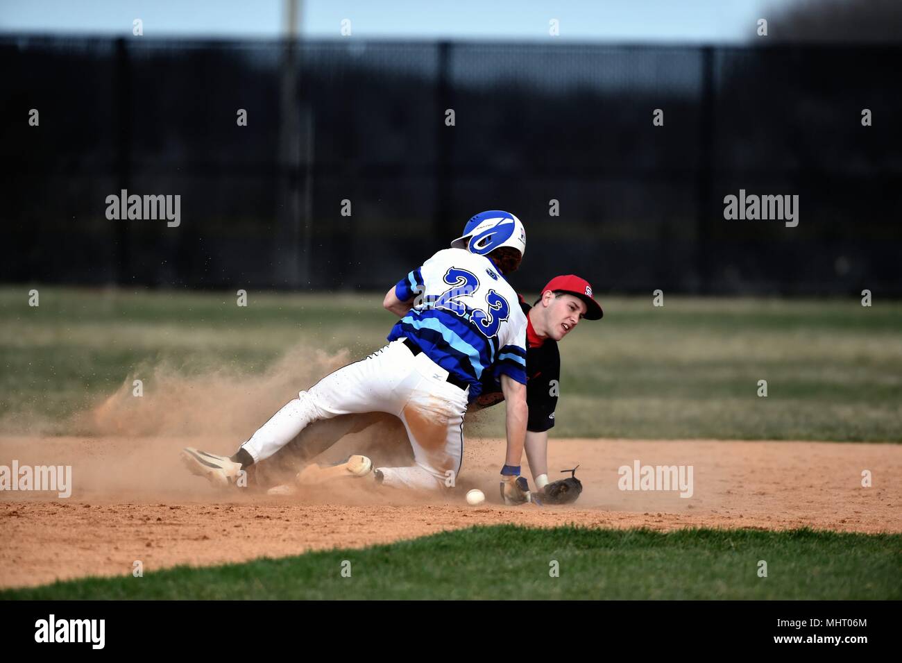 Baserunner is safe after a throw from the shortstop was dropped by the ...