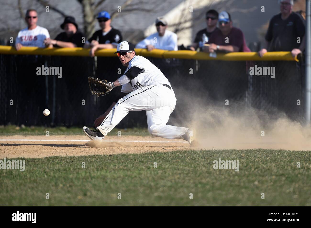 First baseman ranging pff the bag to secure an errant throw that ...