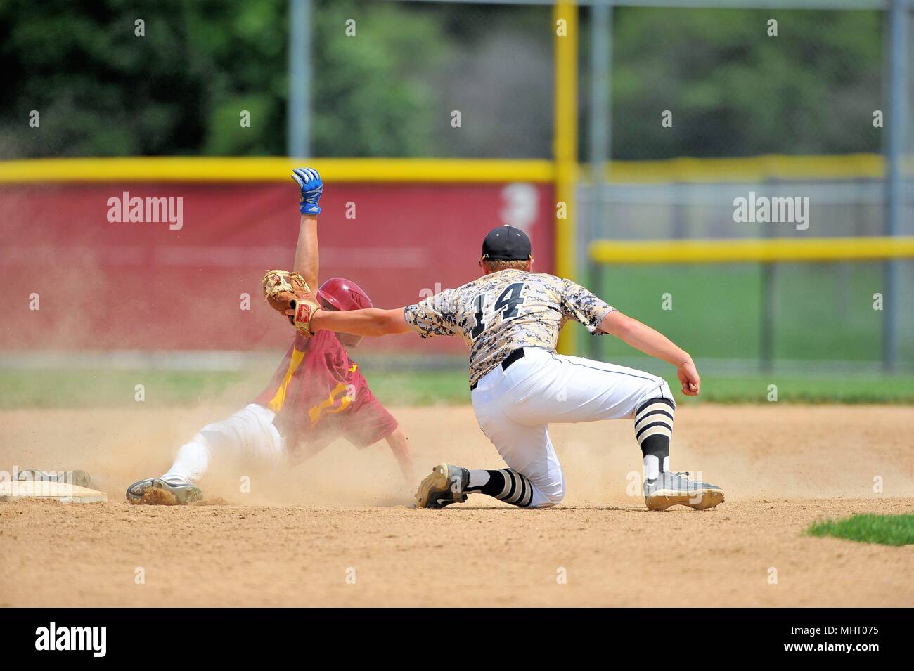 Baserunner sliding in safely to second base as he was ruled that the ...